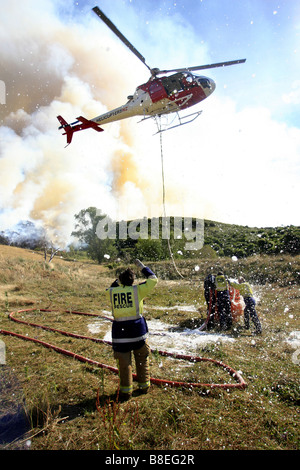 firefighters fill the monsoon bucket for a helicopter fighting a ...