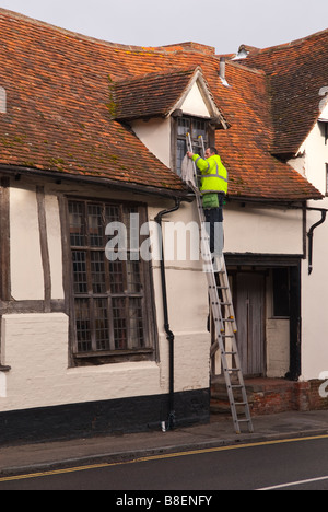 Window cleaner up ladders Stock Photo - Alamy