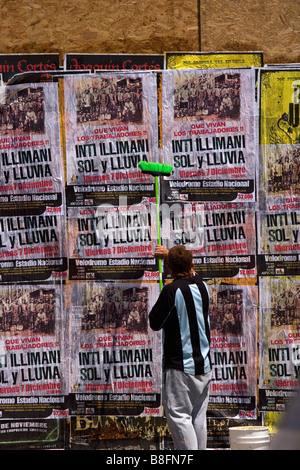 Man putting up posters billboards, Oxford Street, London, England, UK ...