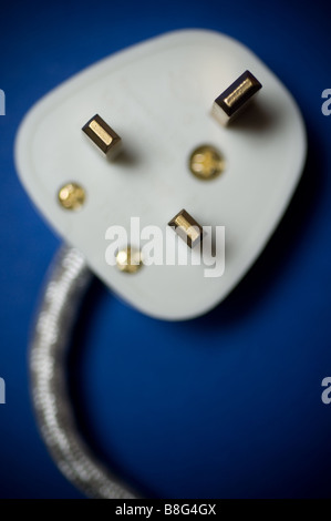 A 240 volt British electrical plug on a blue background Stock Photo - Alamy