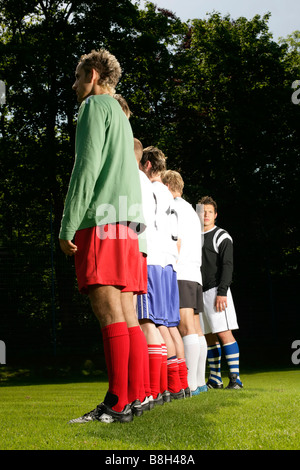 Low angle view of footballers standing on soccer field during practice ...