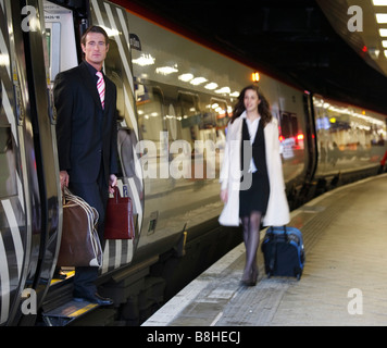 Businesswoman boarding train Stock Photo - Alamy
