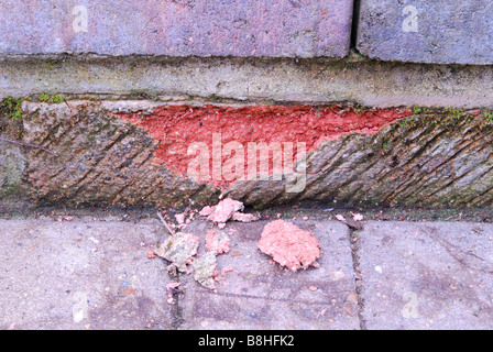 Effects of frost shattering on a moss-covered house brick, showing the ...