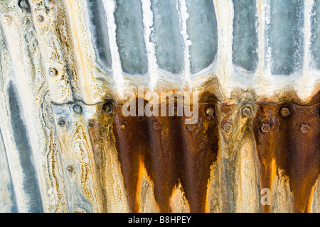 A close-up view of a rusty metal surface reveals textures and patterns ...