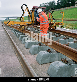 Contractor using road-rail machine to lift long lengths of welded rail ...