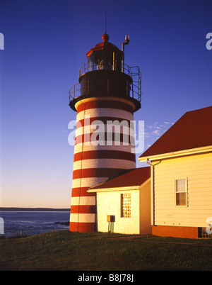 Sunset by West Quoddy Head lighthouse, with its red and white stripes ...