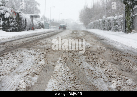 Slush in road that has been salted in winter, Llanfoist, UK Stock Photo ...