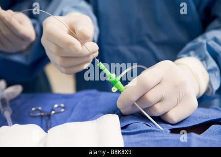 Surgeon Inserting Tube Into Patient During Surgery Stock Photo - Alamy