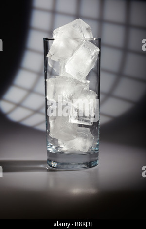 Ice cubes melting in glass or plastic cup showing change in physical ...