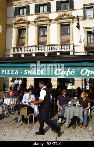 Verona Restaurant; a waiter serving drinks to customers sitting ...
