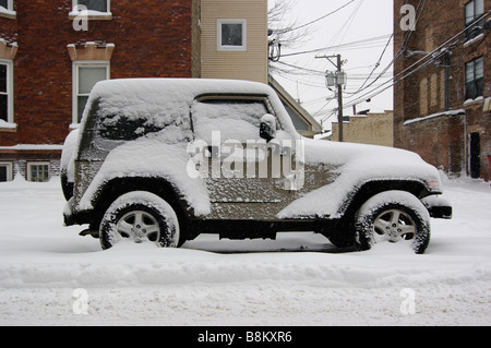 A Jeep wrangler covered in snow at sunset on a cold winter day Stock ...