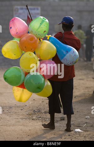 Boy selling balloons Stock Photo - Alamy