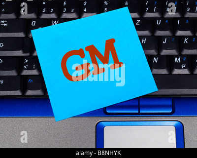 Memo note on notebook, GM, General Motors Stock Photo - Alamy