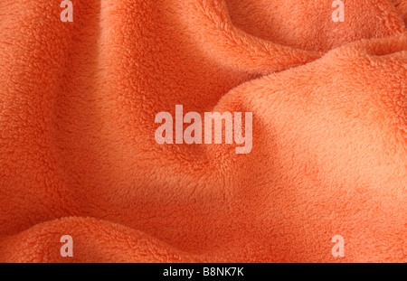 Orange terry towel close-up, soft fabric texture with loops, cozy ...