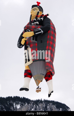 a Cameron SS Piper special shape hot-air balloon flying Stock Photo - Alamy