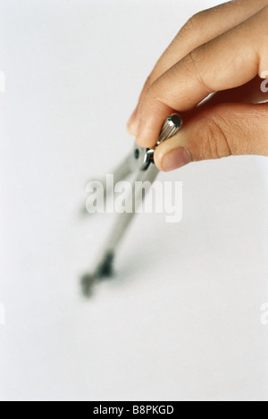 Hand holding mathematics compass, drawing circles, above shot Stock ...