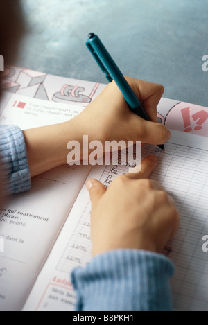 Cropped hand writing in notebook with laptop and smartphone for remote ...