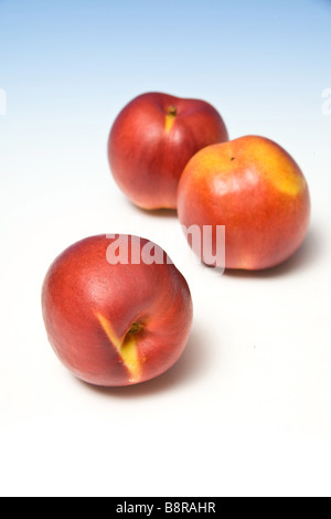 Nectarines on a blue studio background Stock Photo - Alamy