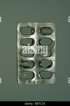 Empty tablet foil pack on red Stock Photo - Alamy