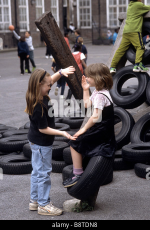 Primary playground with girls playing clapping games Stock Photo - Alamy