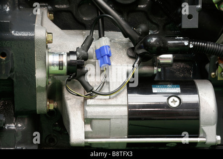 Electric starter on farm tractor engine Stock Photo - Alamy
