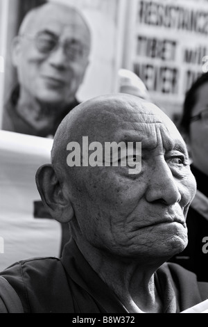 A vertical shot of an Old Tibetan Buddhist in traditional clothing at ...