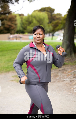 Plus size woman alone run on treadmill at fitness gym and look out ...