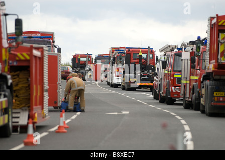Line of UK fire brigade emergency response vehicles outside of ...
