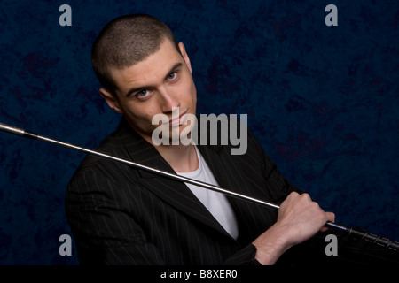 man looking menacing at camera against blue background Stock Photo - Alamy