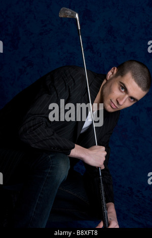 man looking menacing at camera against blue background Stock Photo - Alamy