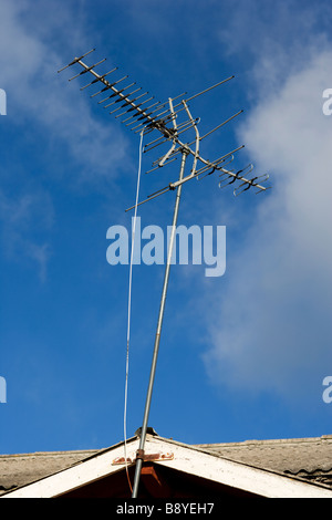 Low angle view of television aerials on building against clear sky ...