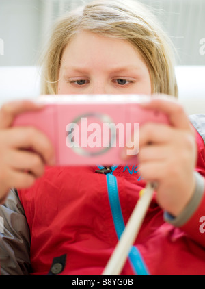 Closeup shot of blonde children playing with pillows on the bed in the ...