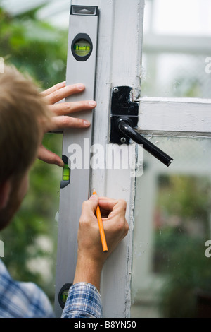 A man using a spirit level Sweden Stock Photo - Alamy