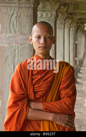 Portrait of a young hindu monk in traditional clothes against black ...