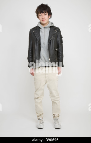 An Asian Man in a Brown Jacket with a Small Notebook in His Hands Stock ...