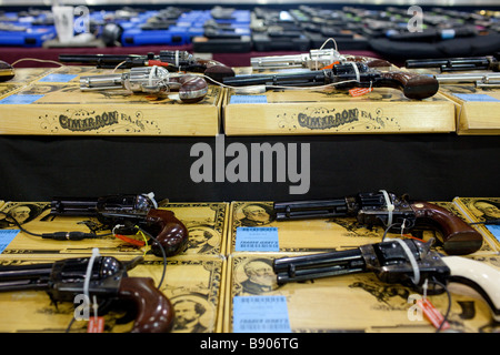 Guns are displayed on a vendors table for sale at a gun show in ...
