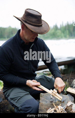 A man making a camp fire Sweden Stock Photo - Alamy