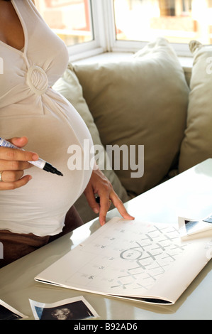 Pregnant woman marking off a calendar Stock Photo - Alamy