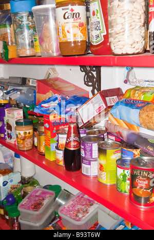A cluttered untidy larder pantry housing lots of jars and empty food ...