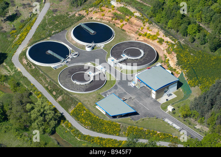Sewage treatment plant works the rotating arm pours sewage over the ...