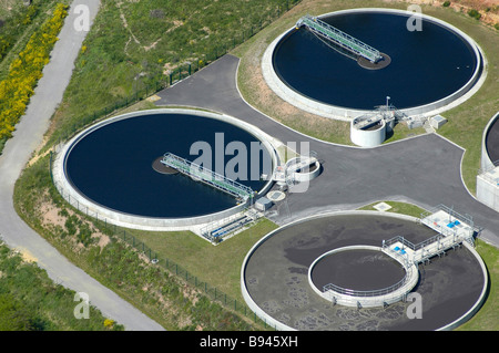 Sewage treatment plant works the rotating arm pours sewage over the ...