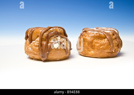 Cream buns on a graduated blue studio background Stock Photo - Alamy