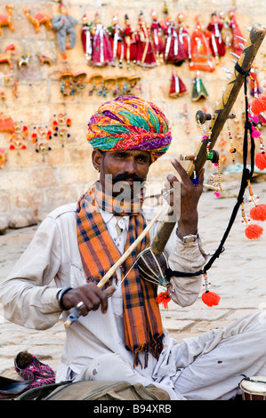 Tribal musician playing a traditional musical instrument, Nagada. Uraov ...