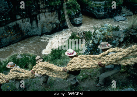 PERU Apurimac River Gorge Chumbivilcas Hills men carrying thick grass ...