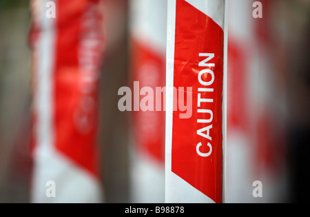 Plastic caution wrapping on scaffolding poles Stock Photo - Alamy