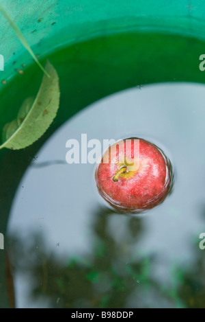 Red apple floating in water with splashes isolated on black background ...