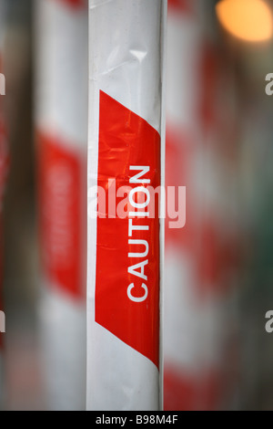 Plastic caution wrapping on scaffolding poles Stock Photo - Alamy