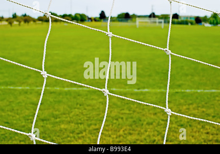 The soccer field view through white square gate net. Football sport ...