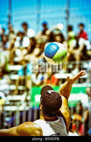 Beach volleyball player hitting the volley ball Stock Photo - Alamy