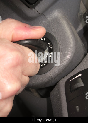 a hand on the ignition key of a car Stock Photo - Alamy